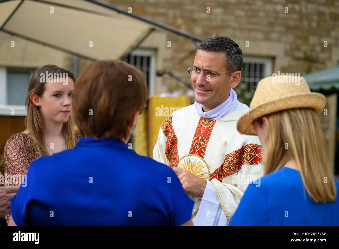 A priest talking to the faithful after a Holy Mass Stock Photo - Alamy