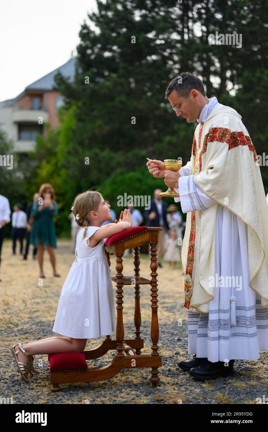 A child receiving the First Holy Communion Stock Photo - Alamy