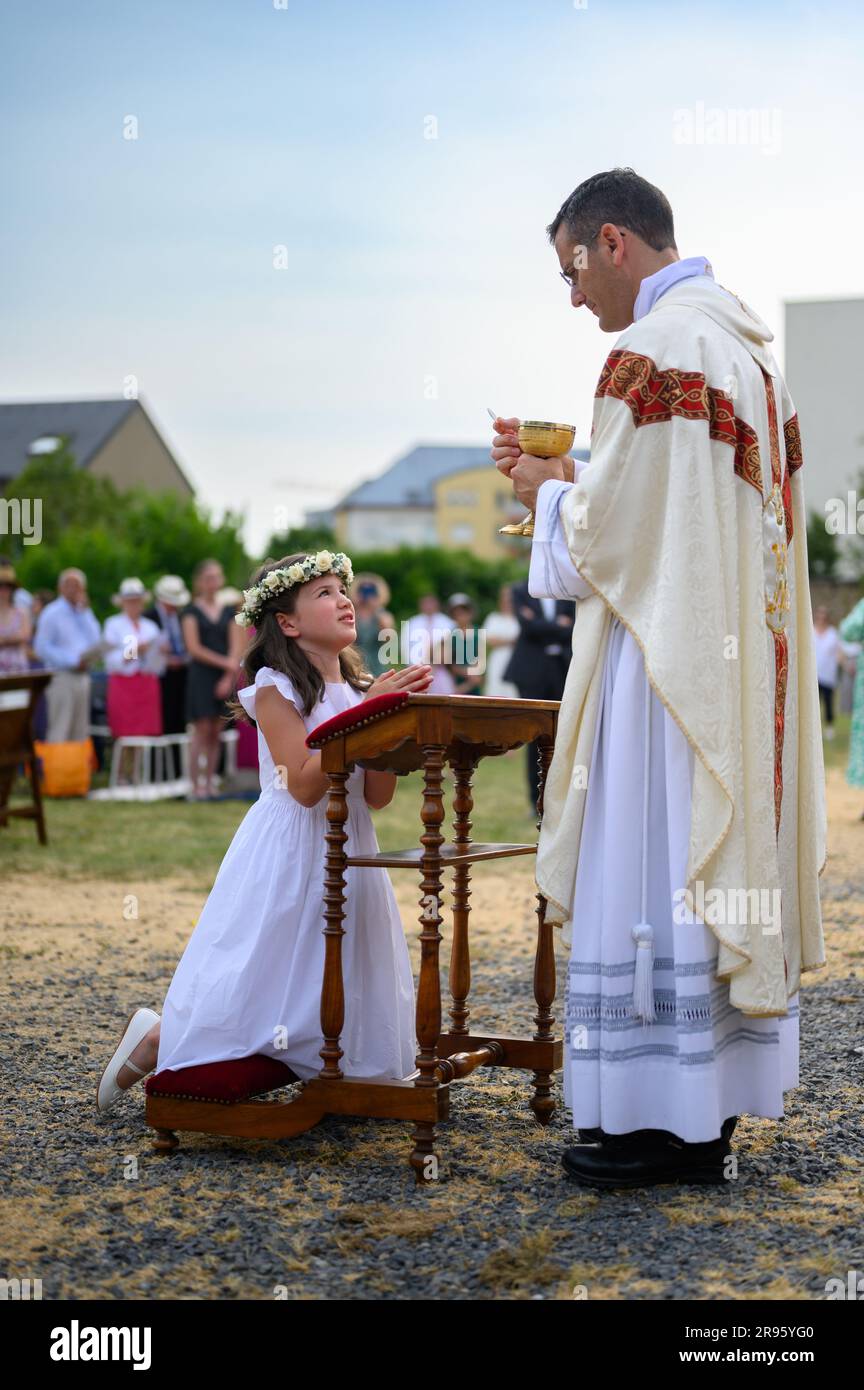 A child receiving the First Holy Communion Stock Photo - Alamy