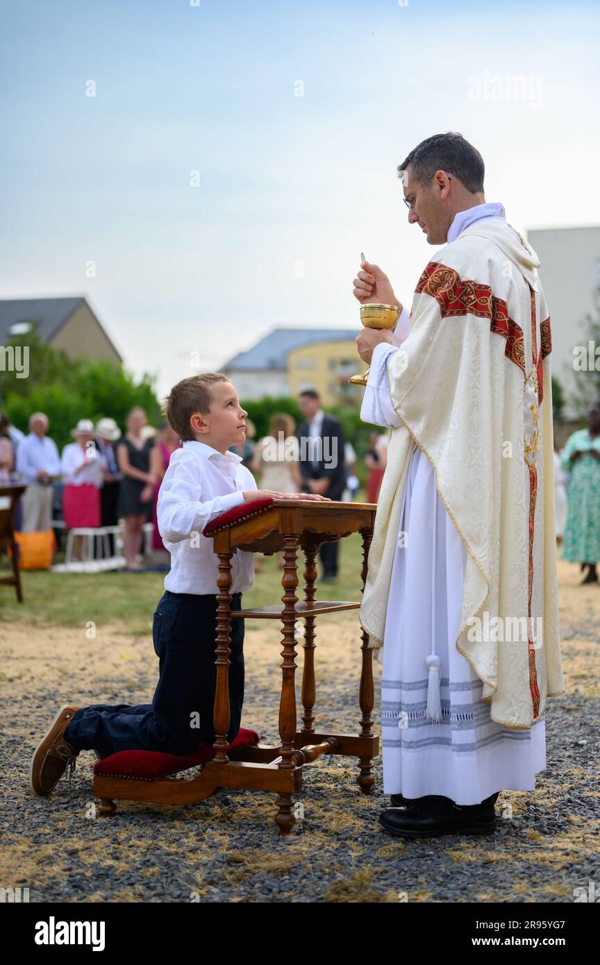 A child receiving the First Holy Communion Stock Photo - Alamy
