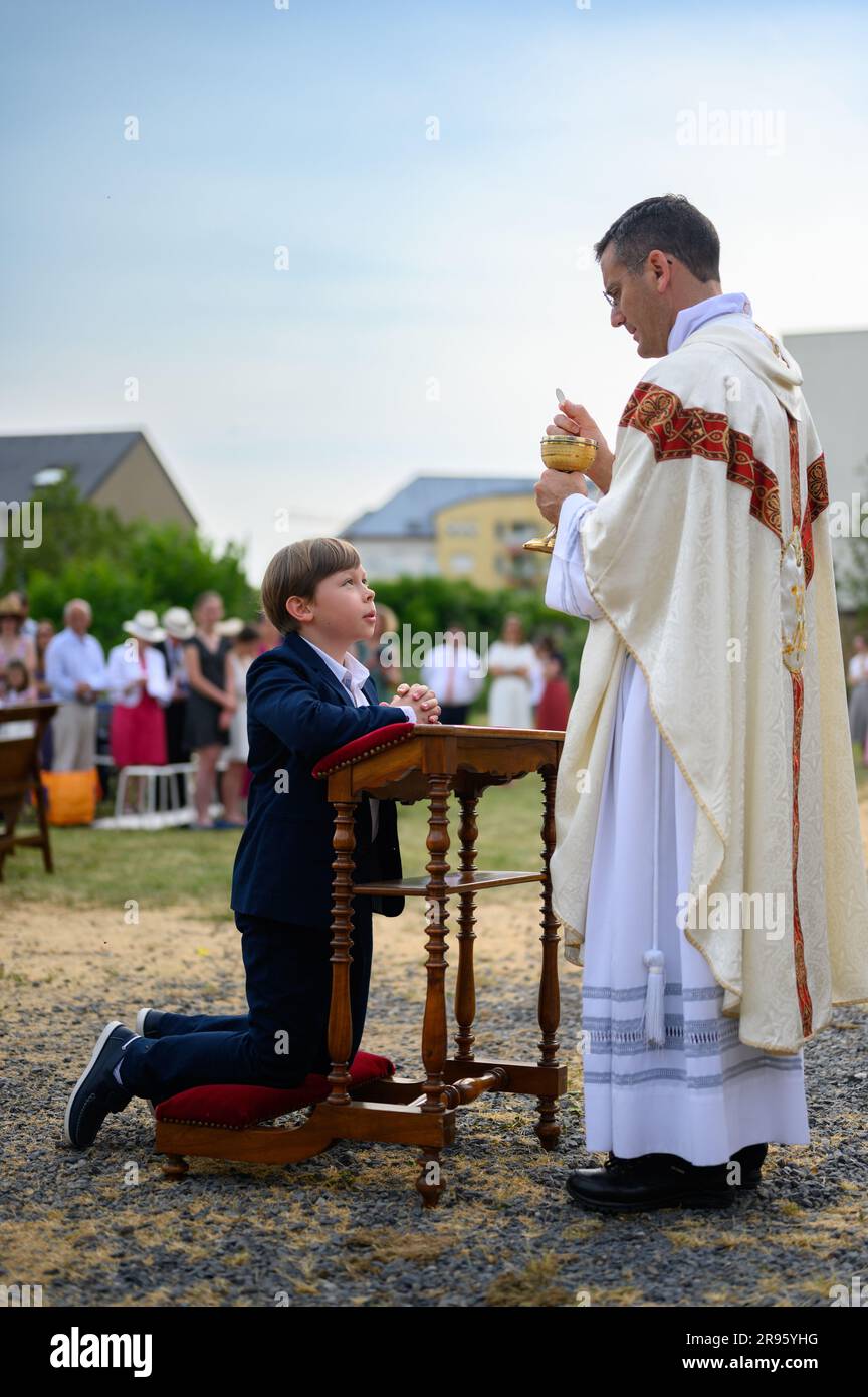 A child receiving the First Holy Communion Stock Photo - Alamy