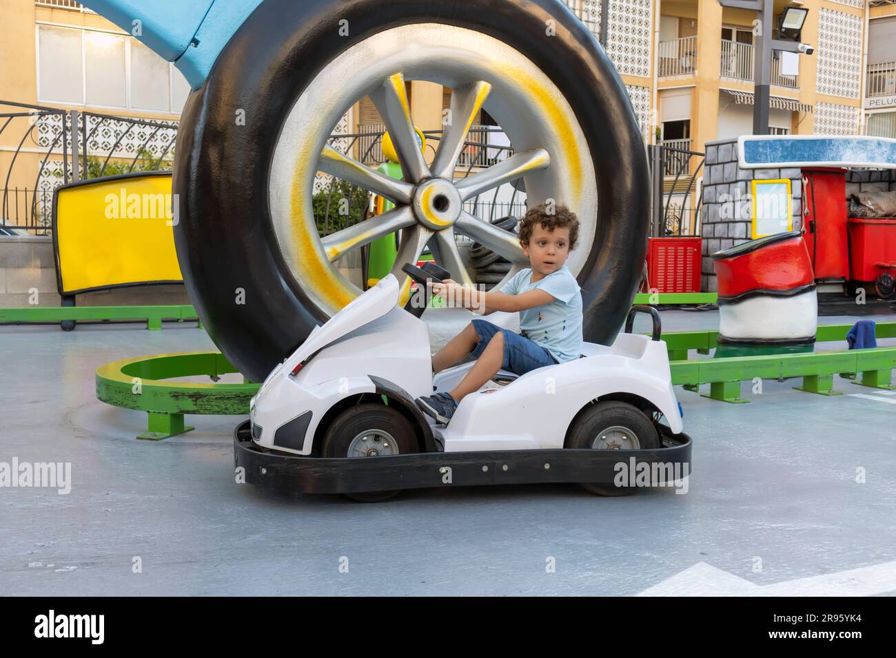 lovely child in a kart on children's track Stock Photo - Alamy