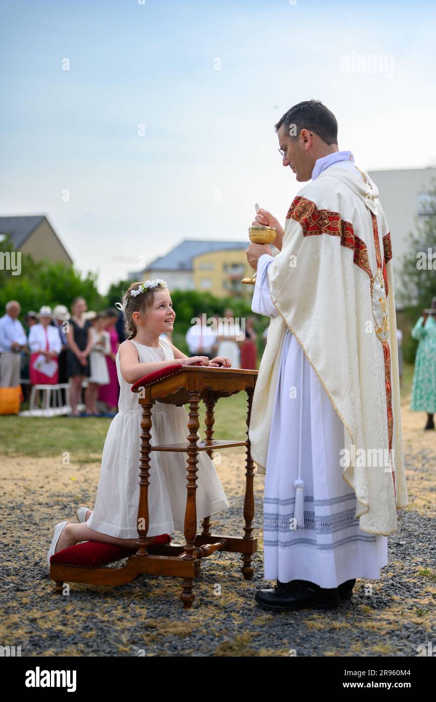 A child receiving the First Holy Communion Stock Photo - Alamy