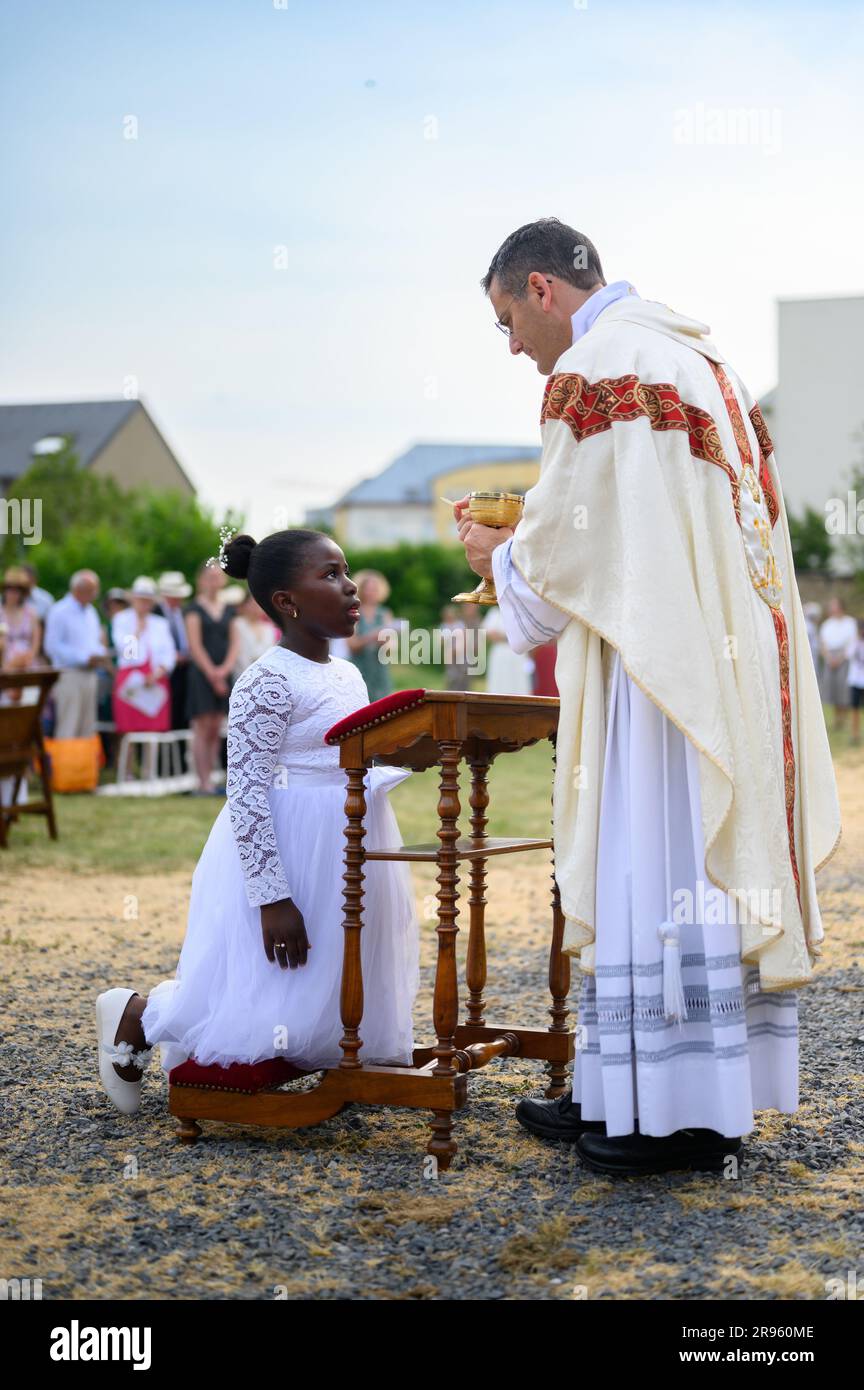 A child receiving the First Holy Communion Stock Photo - Alamy