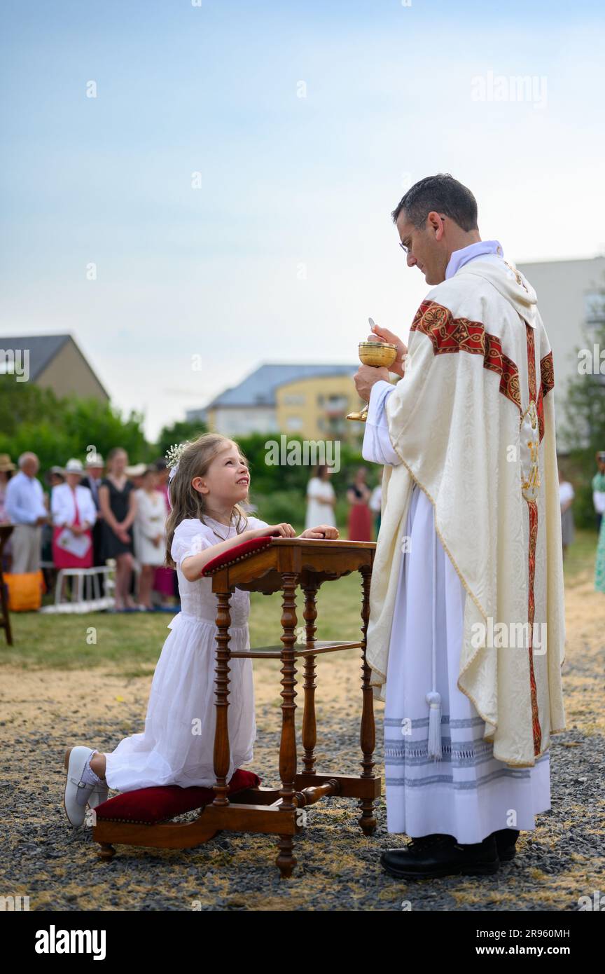 A child receiving the First Holy Communion Stock Photo - Alamy