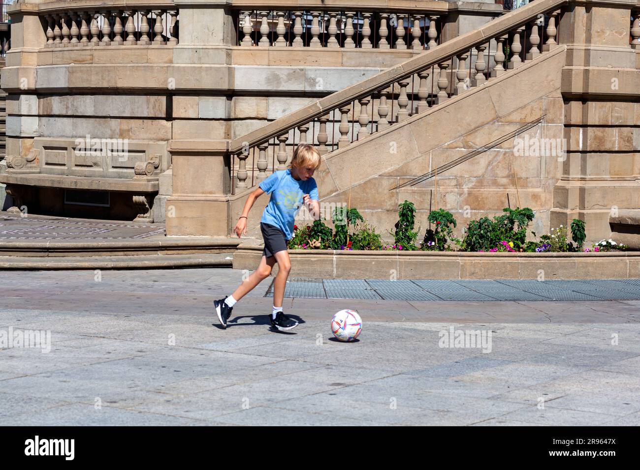 Pamplona, Spain - July, 31: A caucasian child playing football in the ...