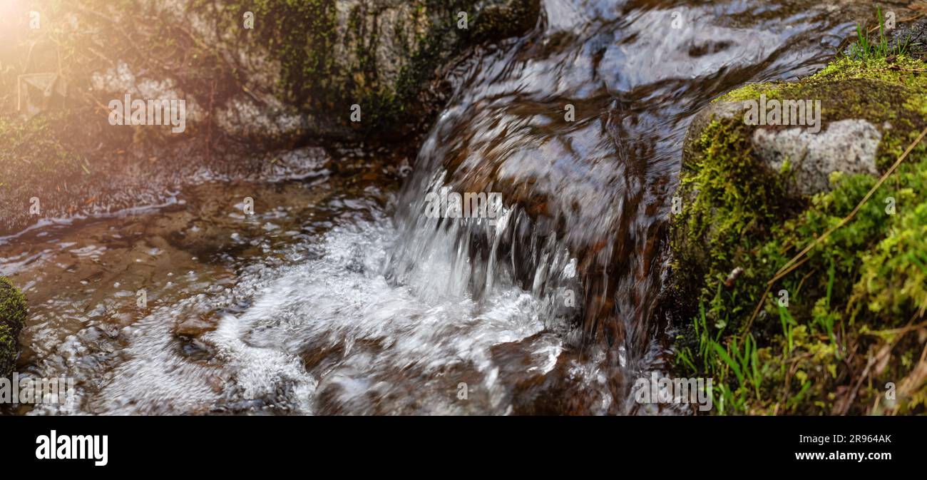 Fresh Water running down the River Stream around the smooth rocks Stock ...