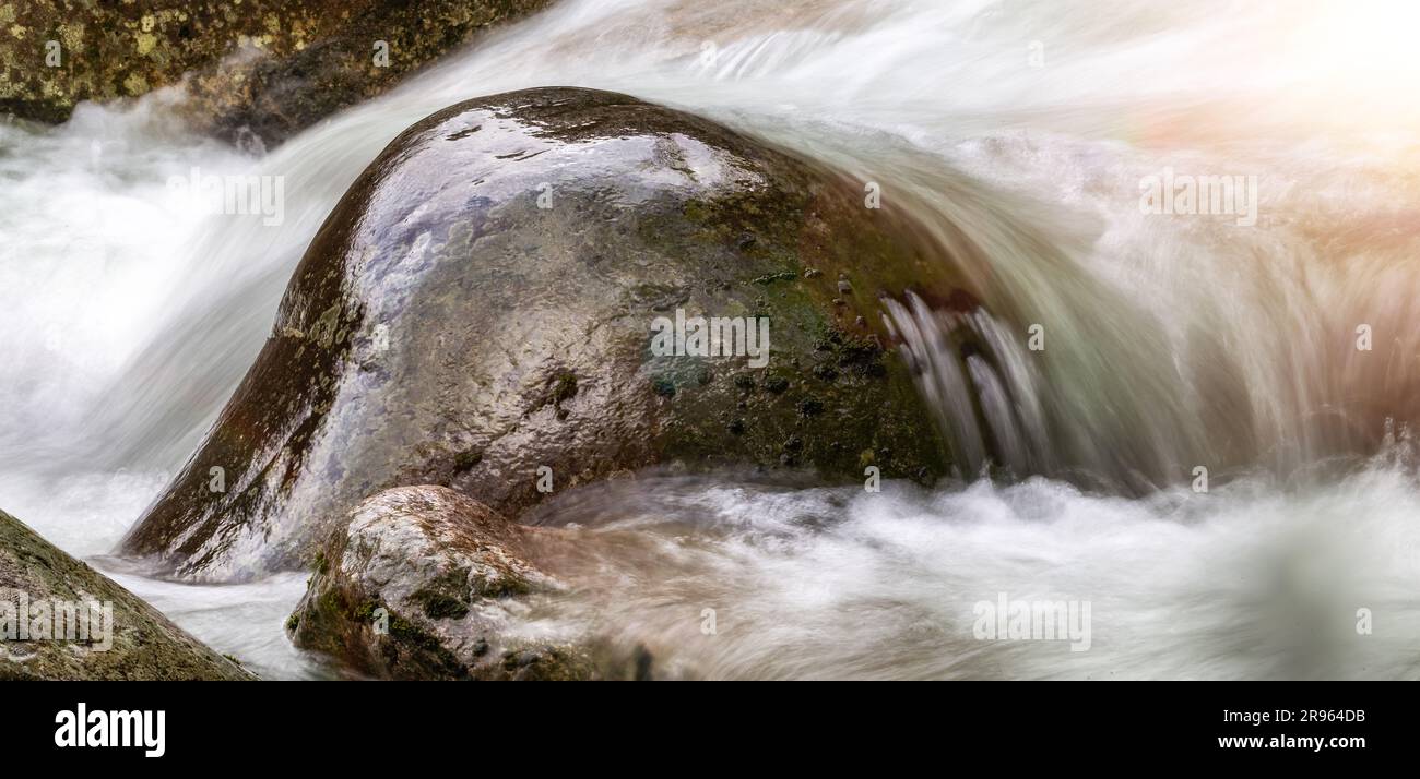 Fresh Water running down the River Stream around the smooth rocks Stock ...
