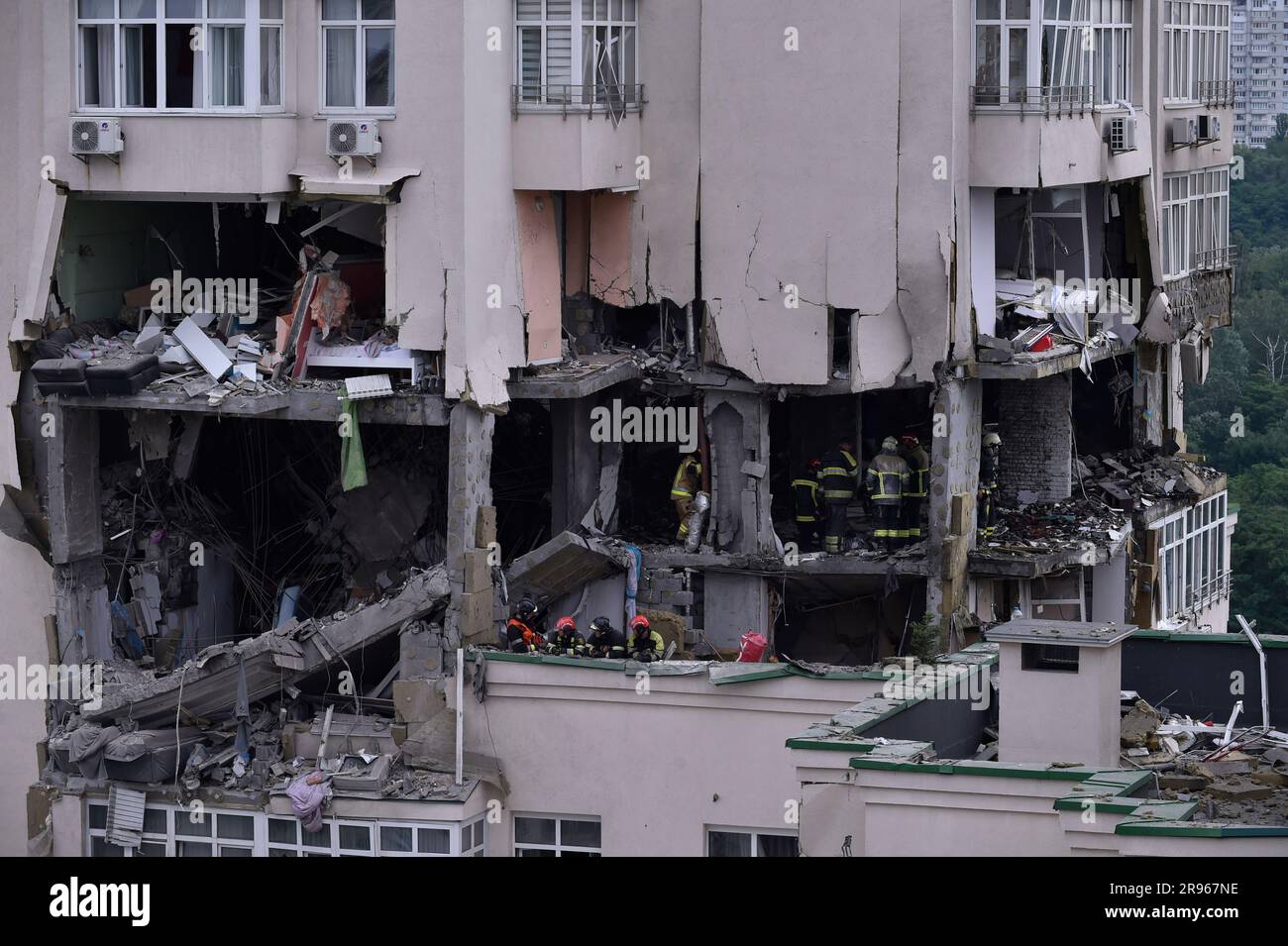Kyiv, Ukraine. 24th June, 2023. Rescuers clear the rubble damaged multi ...