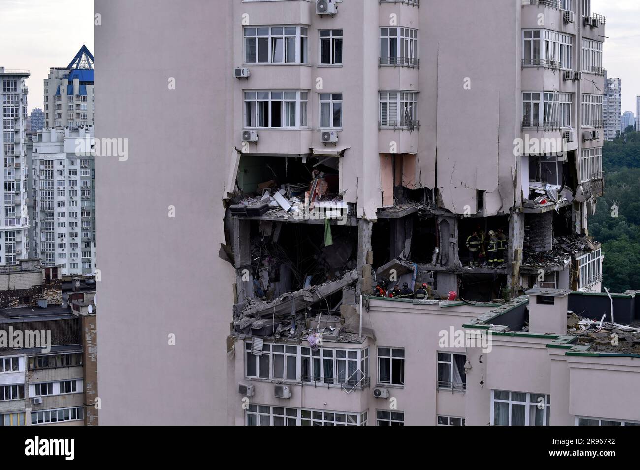 Kyiv, Ukraine. 24th June, 2023. Rescuers clear the rubble damaged multi ...