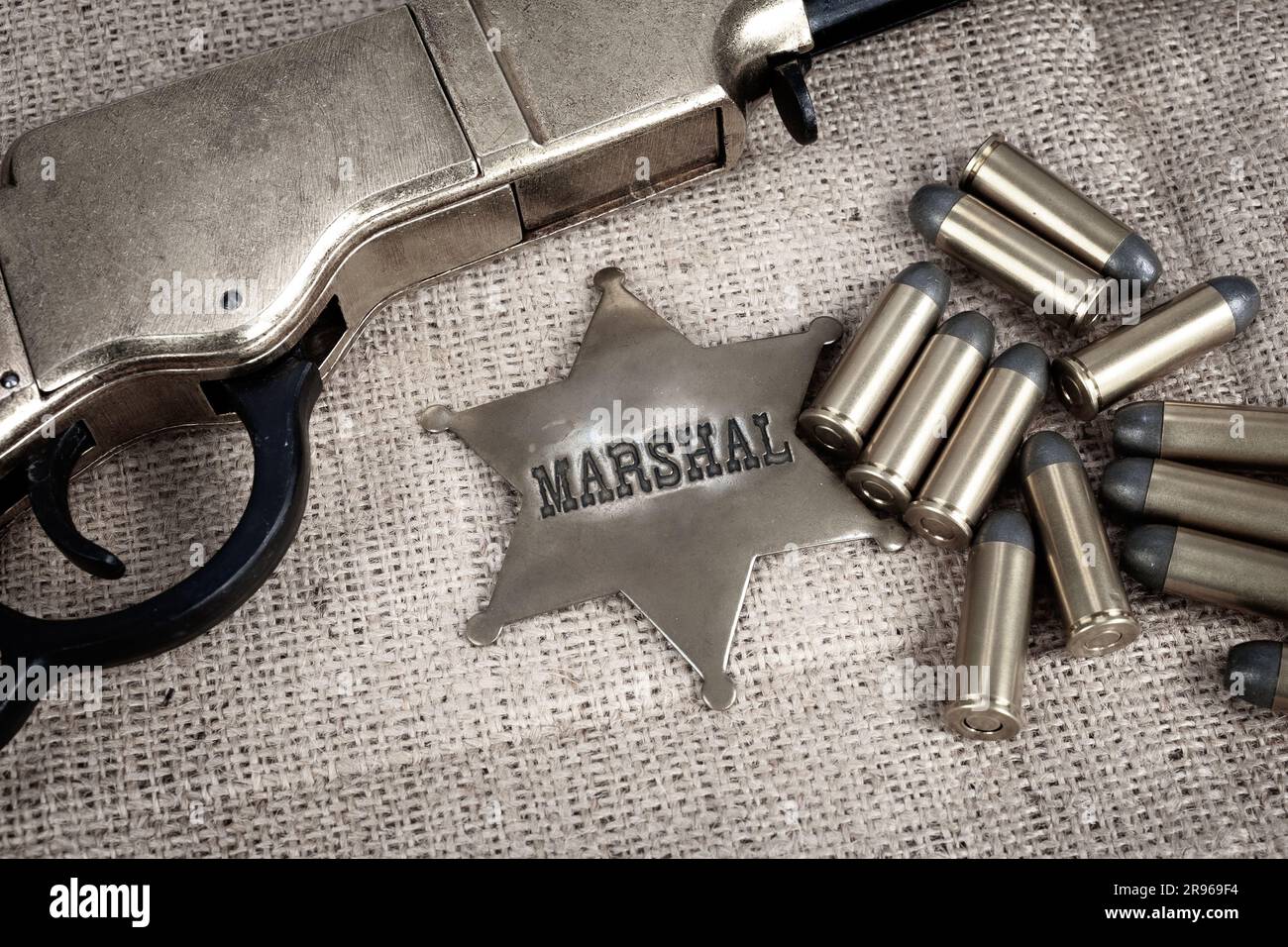 Old west marshal badge with ammunition background Stock Photo - Alamy