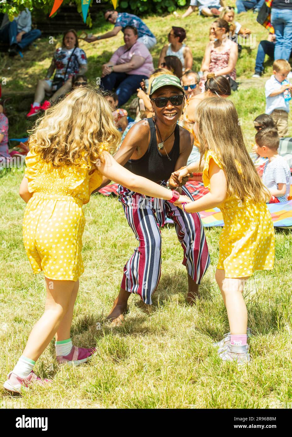 Two young girls and a woman dancing at the Leigh Folk Festival, Leigh ...