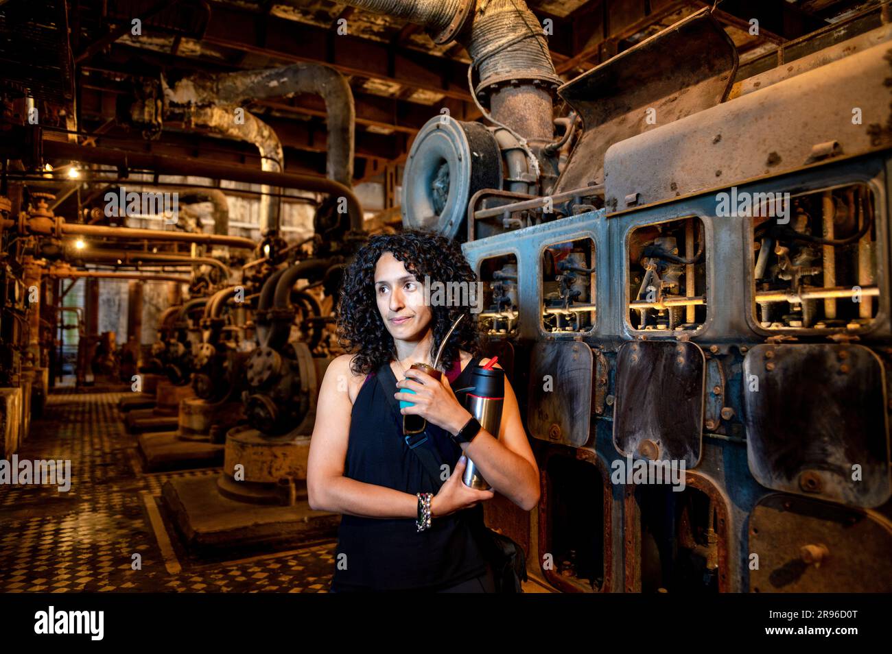 Portrait of a mixed race woman smiling while posing inside an abandoned ...