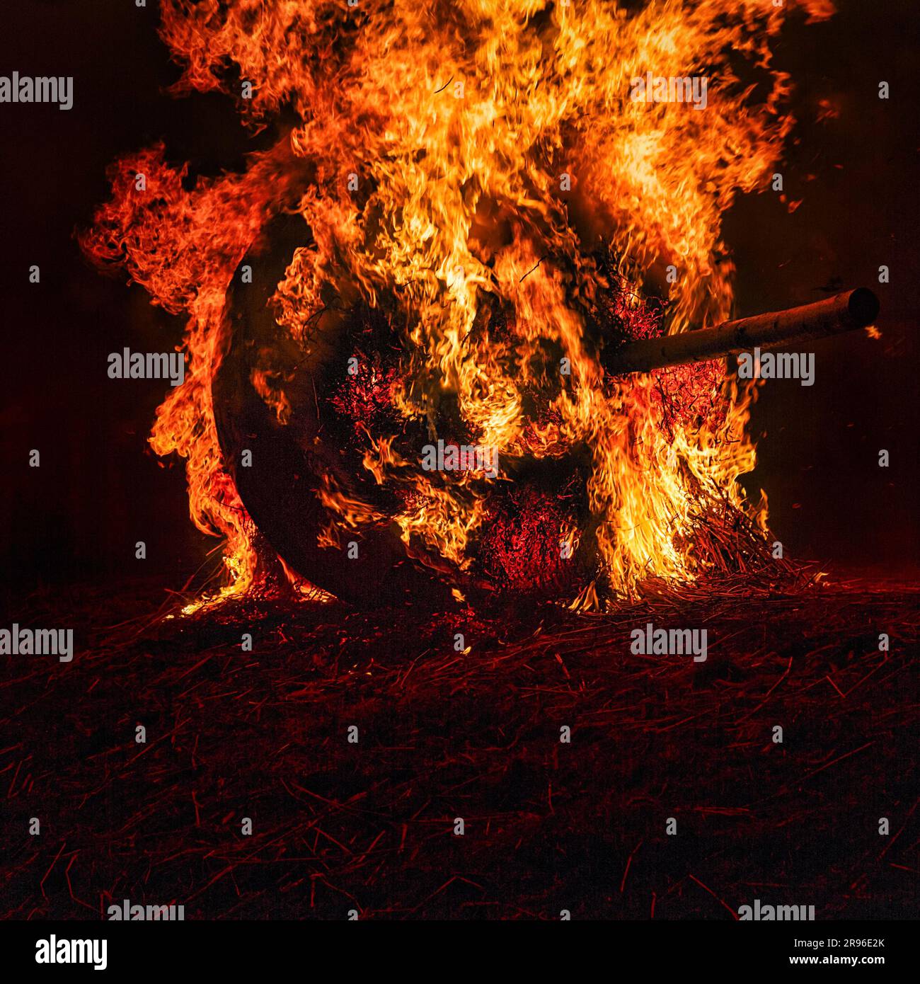 Fire wheel, burning wooden wheel rolls in the night, Easter festival ...