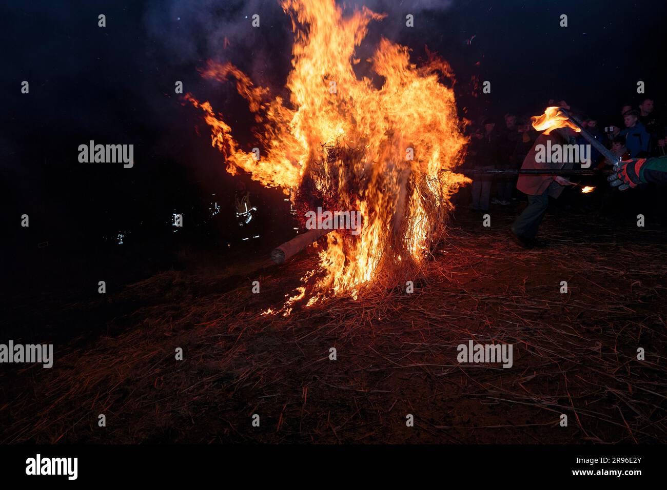 Fire wheel, burning wooden wheel rolls in the night, Easter festival ...