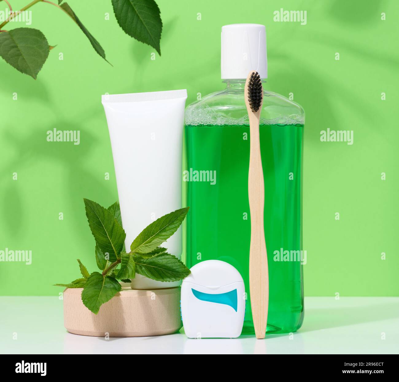 Refreshing mouthwash in a transparent plastic bottle and dental floss ...