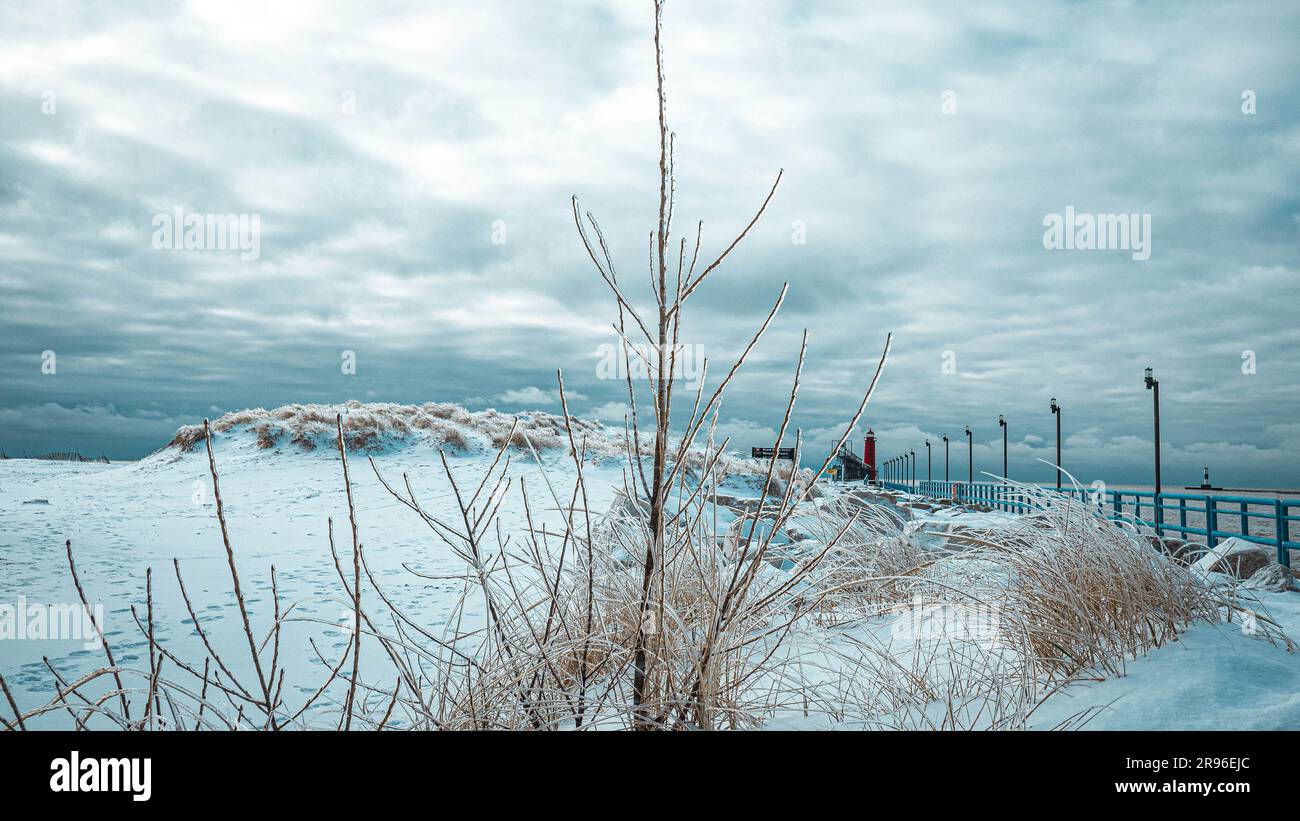 A scenic winter landscape featuring a field with snow-covered grass ...
