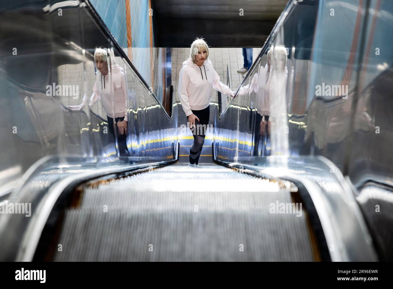 Made-up transvestite, crosdresser, with blond wig and hoody, portrait ...