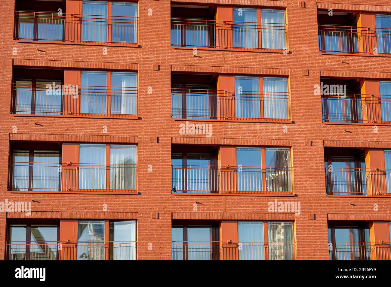 Facade of a modern red apartment building, seen in Frankfurt, Germany ...