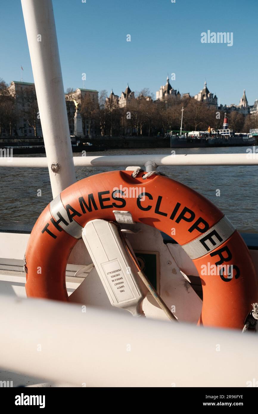 An orange and white life ring atop a boat in a marina or dock Stock ...