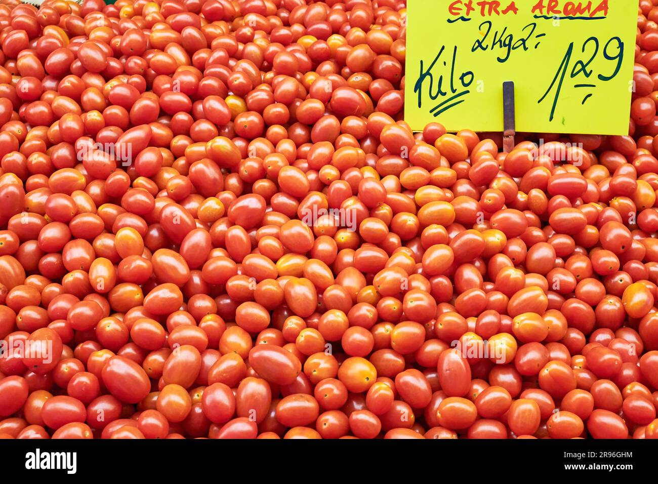 A bunch of small tomatoes for sale at a market Stock Photo - Alamy