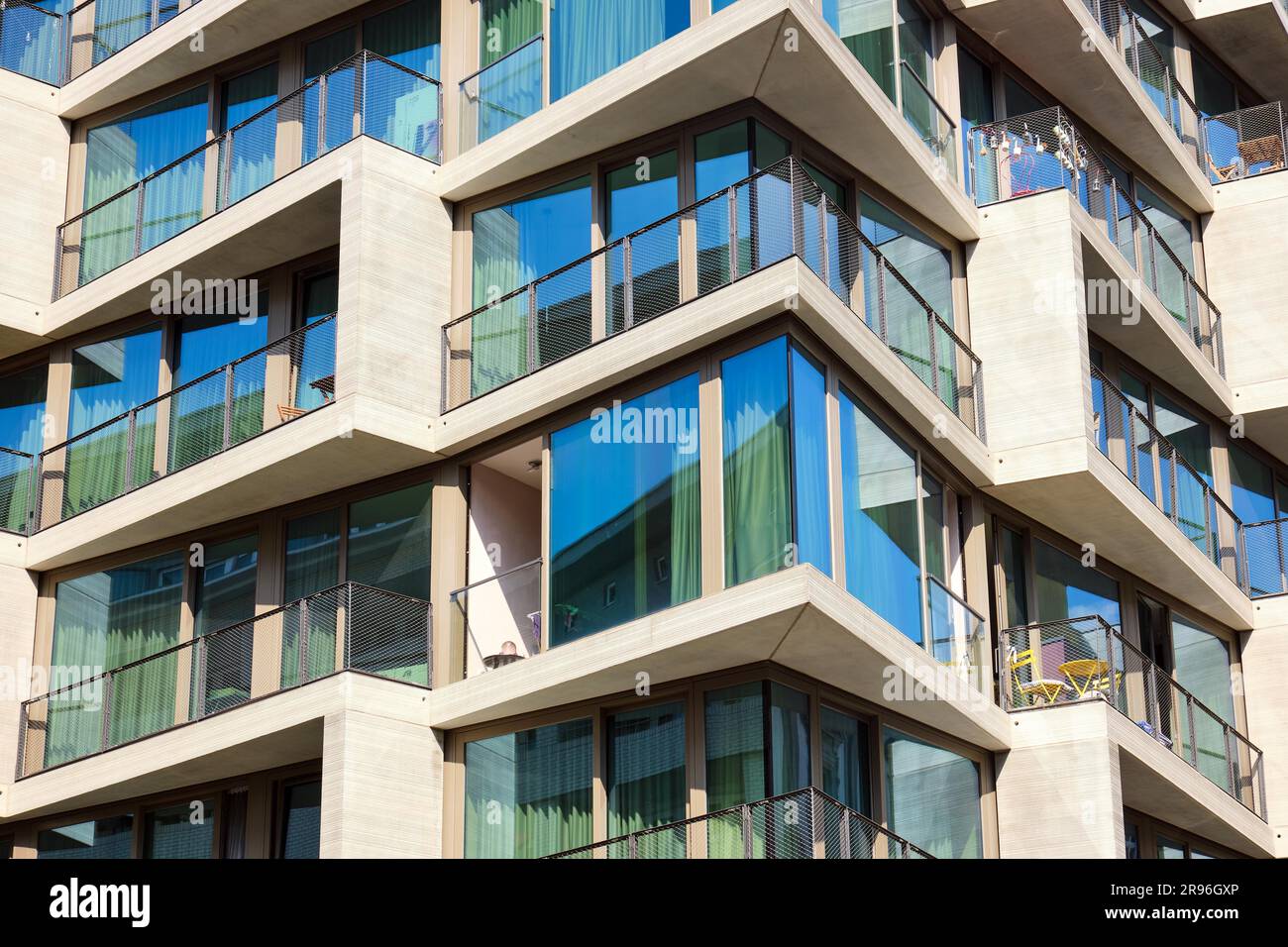 Detail of a modern apartment building with floor-to-ceiling windows ...