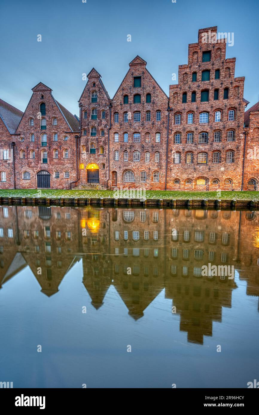 The medieval salt warehouse with the river Trave at dawn, seen in ...