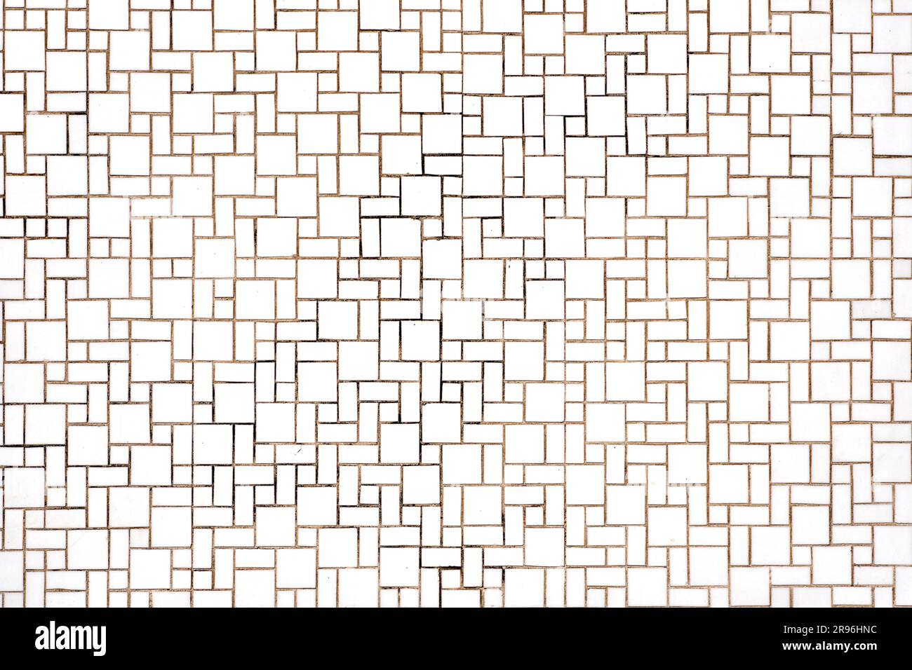 Background made of a wall of rectangular and square white mosaic tiles ...