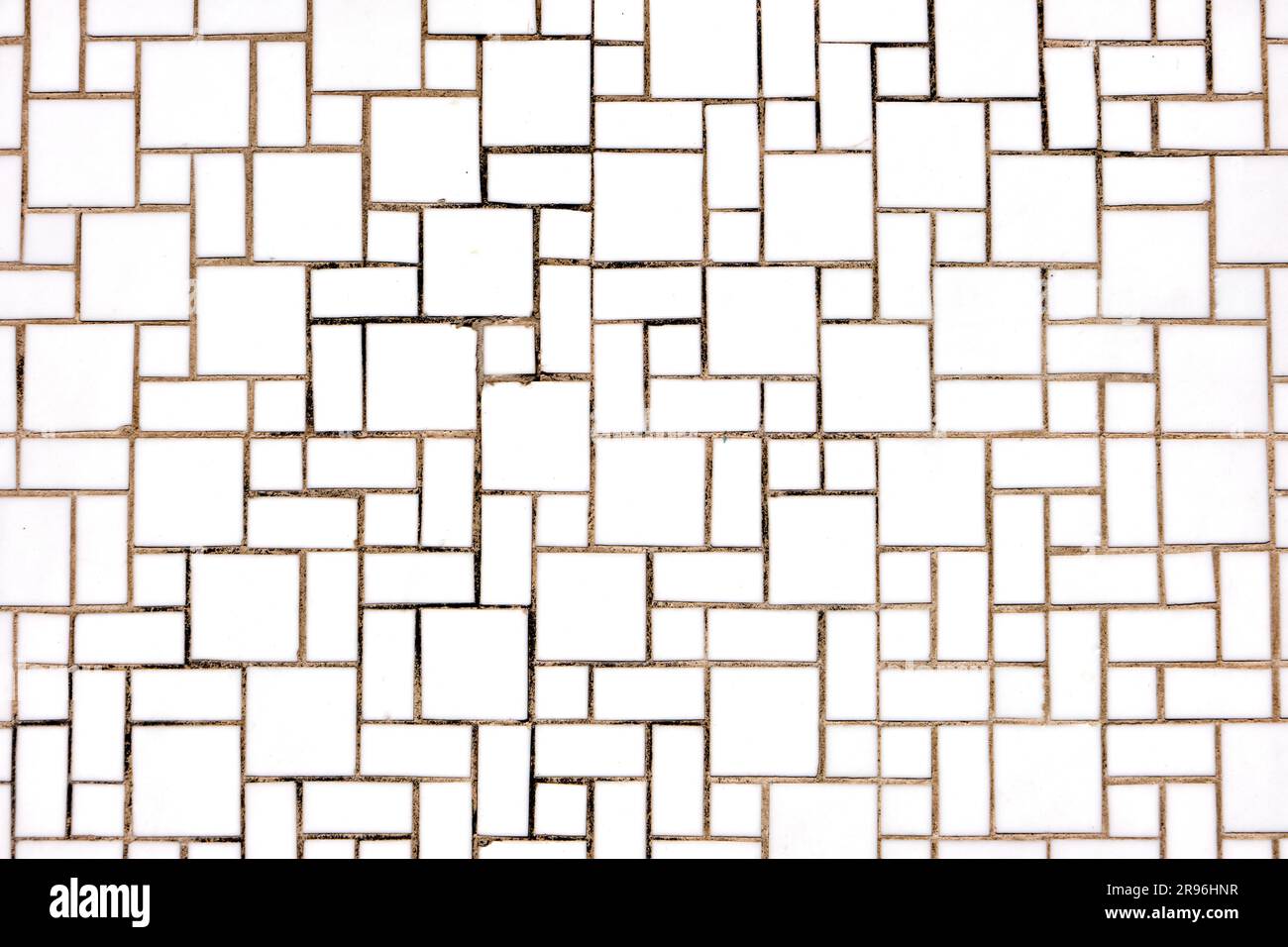Background made of a wall of square and rectangular white mosaic tiles ...