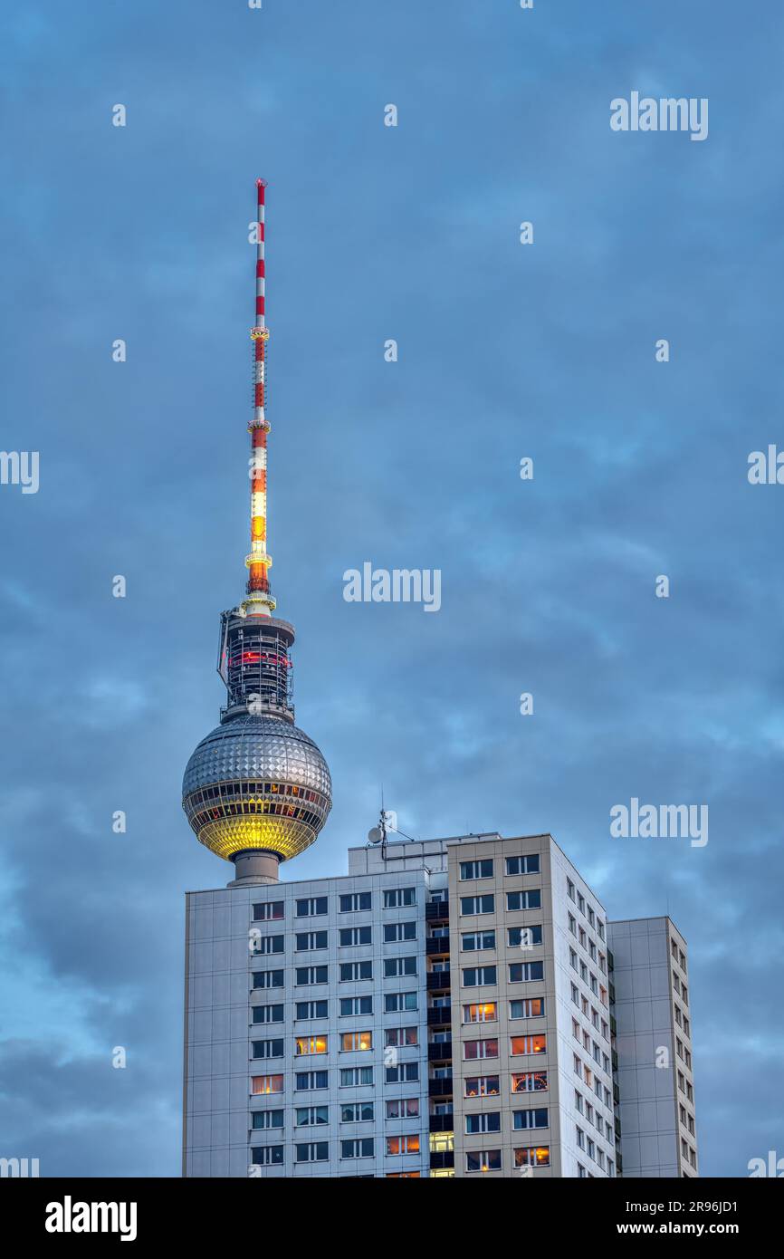 The famous Berlin TV tower at dusk with a typical GDR prefabricated ...