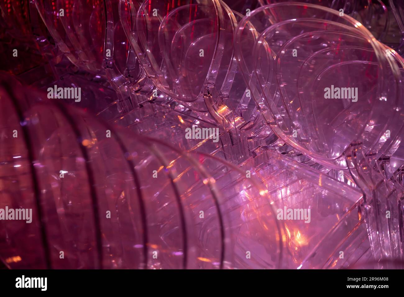 Illuminated Red Plastic Chairs Stacked in Switzerland Stock Photo - Alamy