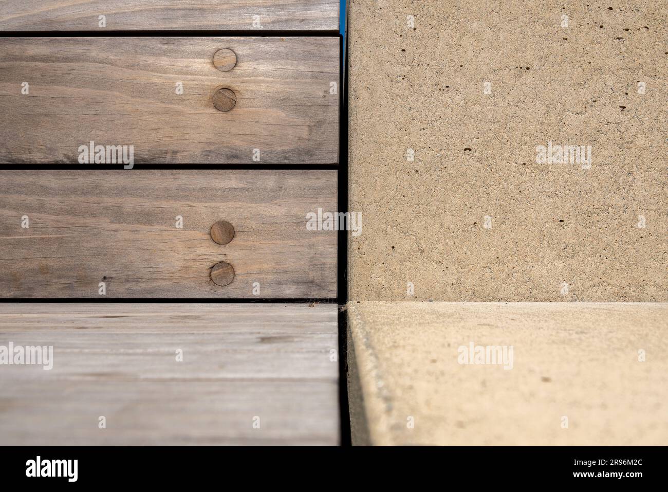 Contrast of shapes and textures, the edge of a wooden bench and a ...