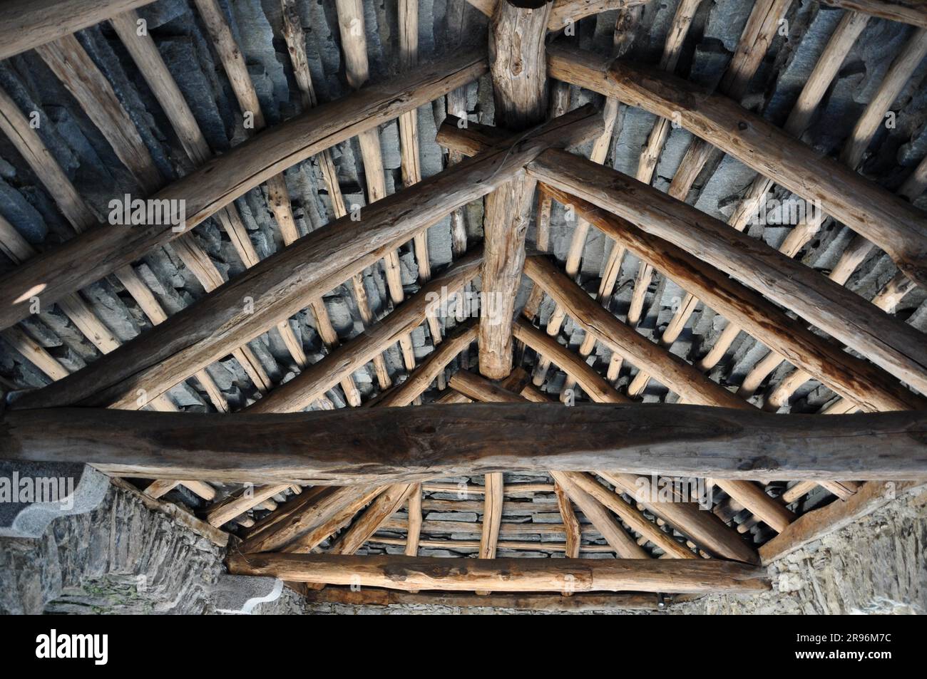Old rustic hut with stone roof and wood beams from indoors in ...