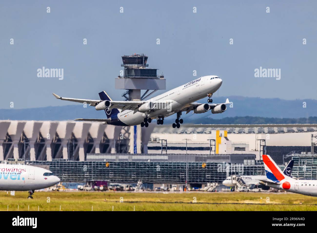Taking off Airbus A340-300 of the airline Lufthansa, tower and terminal ...