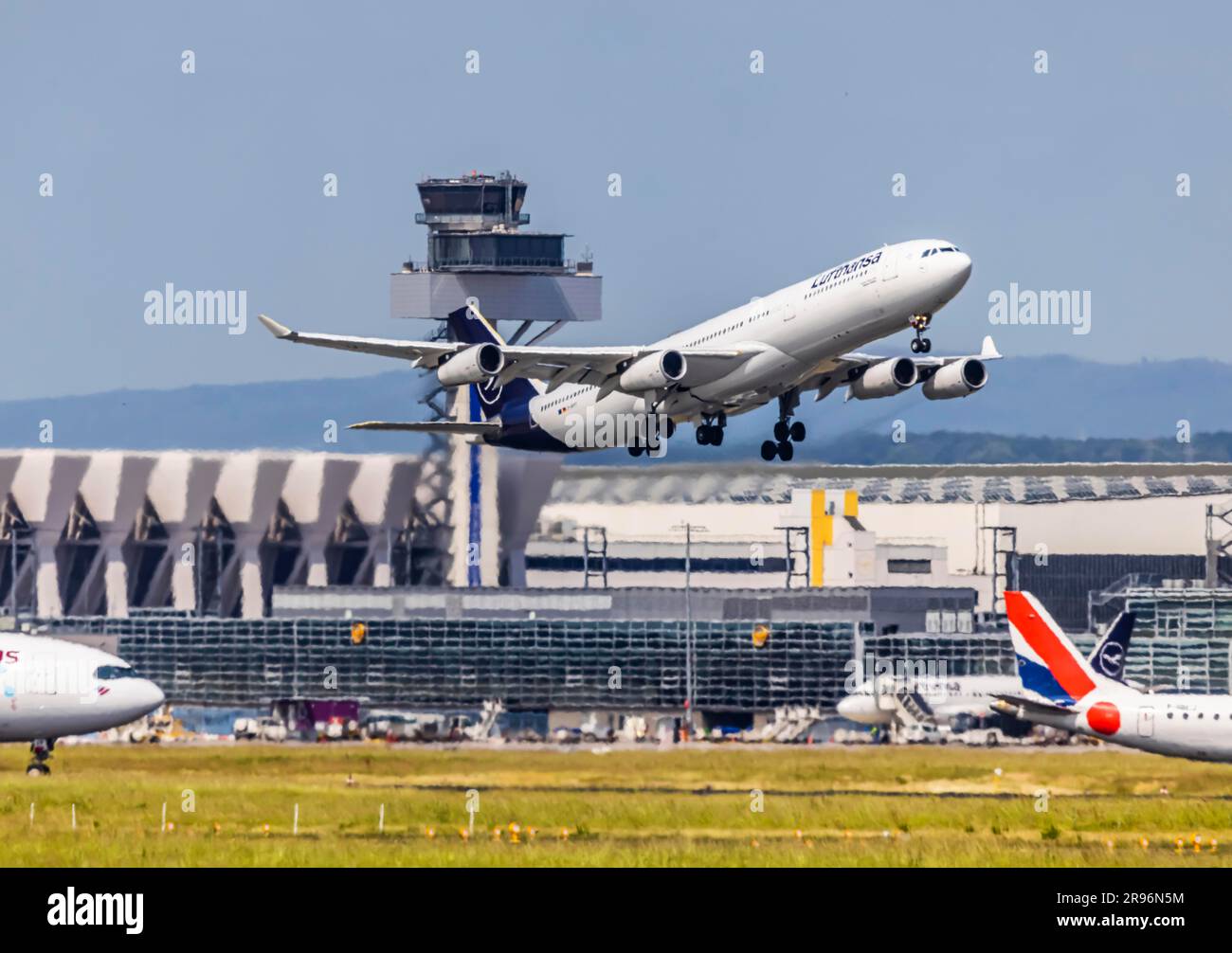 Taking off Airbus A340-300 of the airline Lufthansa, tower and terminal ...