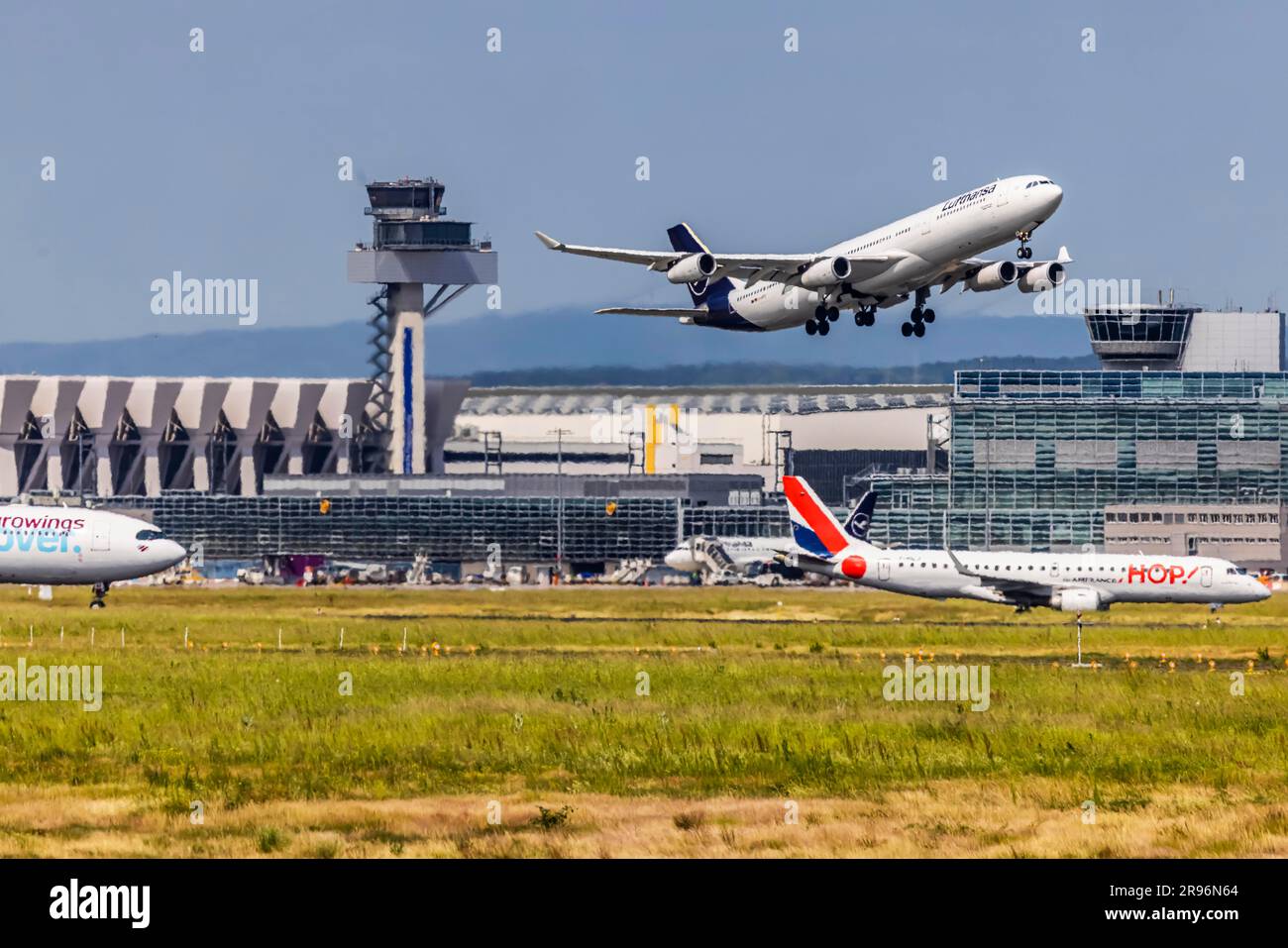 Taking off Airbus A340-300 of the airline Lufthansa, tower and terminal ...