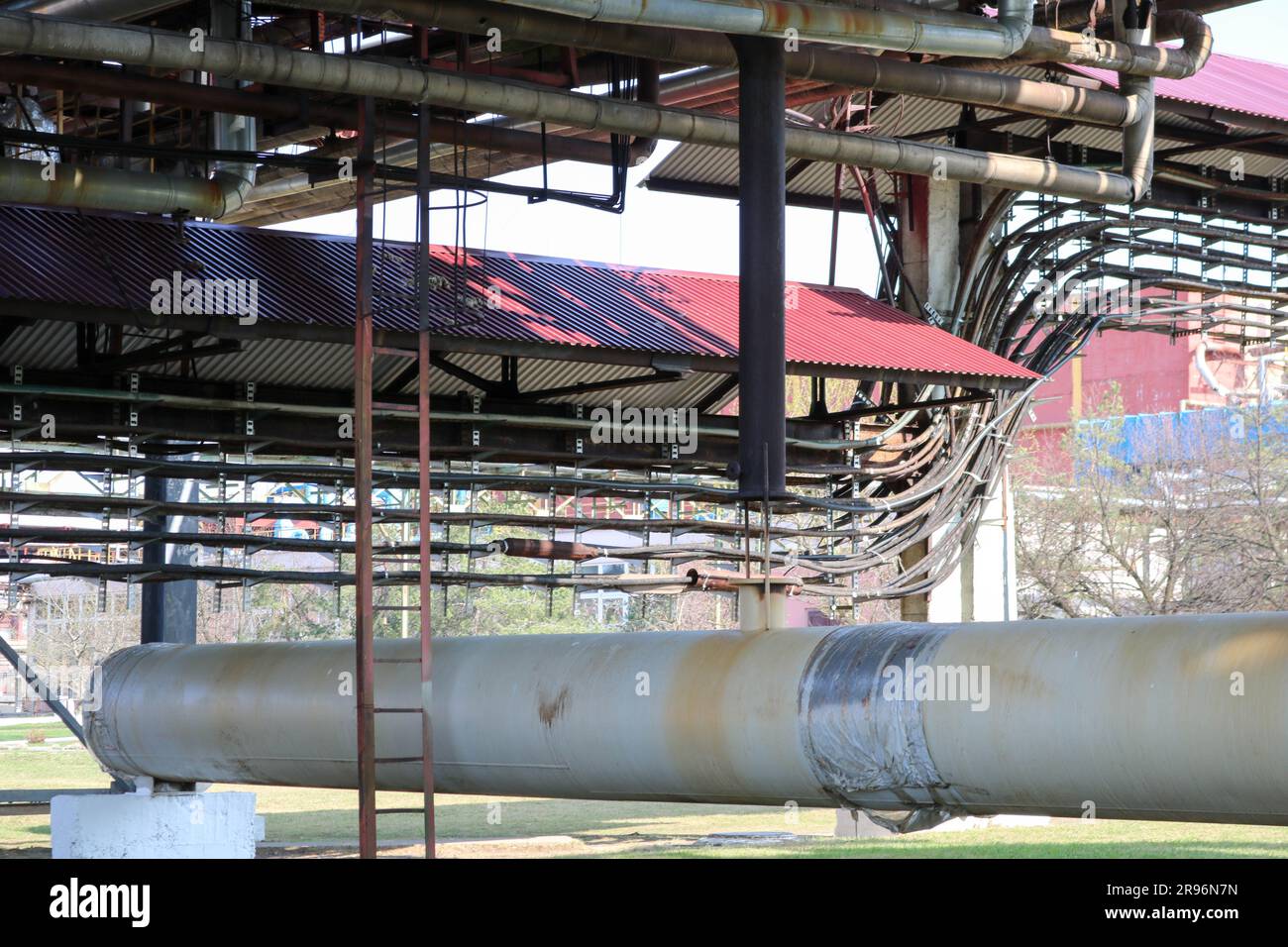 Pipeline overpass with iron rusty pipes for pumping liquid, condensate ...
