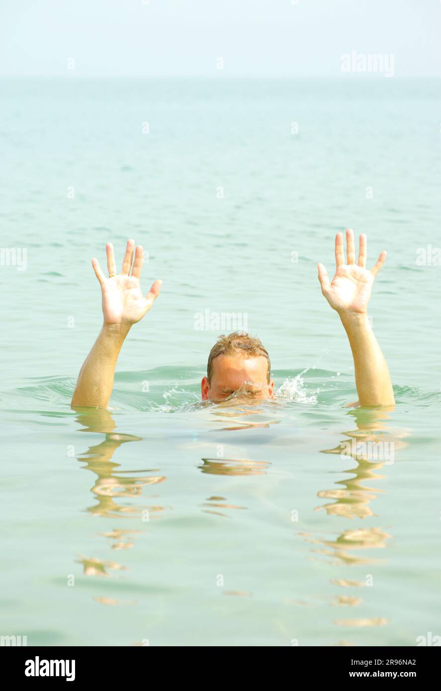 Man in the sea, hands up, drowning, drowning Stock Photo - Alamy