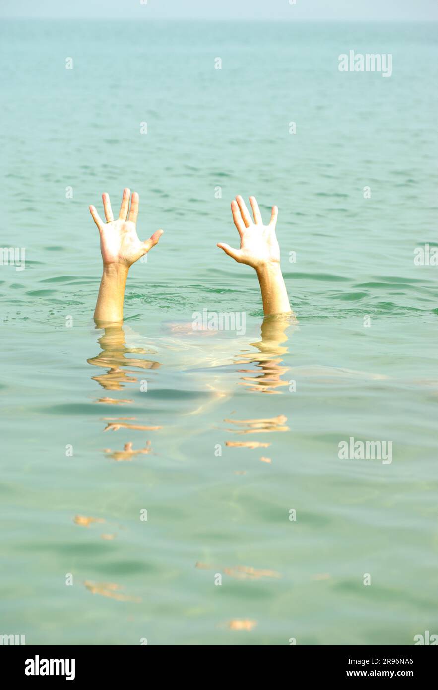 Man in the sea, hands up, drowning, drowning Stock Photo - Alamy