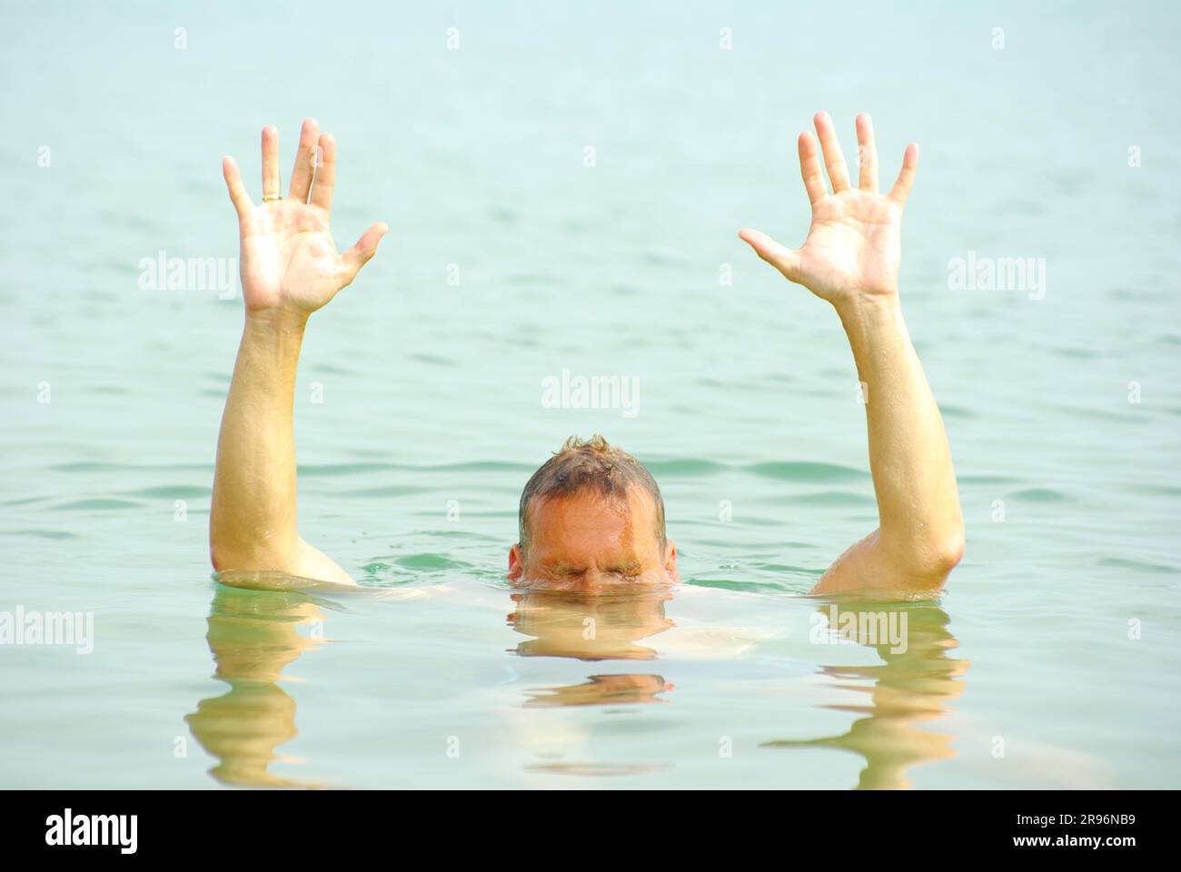 Man in the sea, hands up, drowning, drowning Stock Photo - Alamy