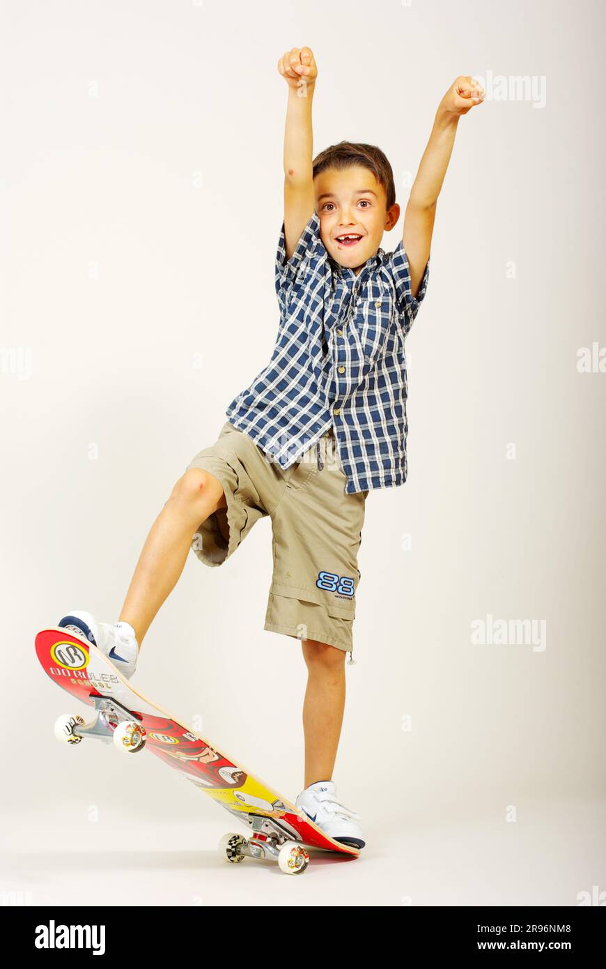 Boy on skateboard, arms up, victory pose, cut-out, free-standing Stock ...