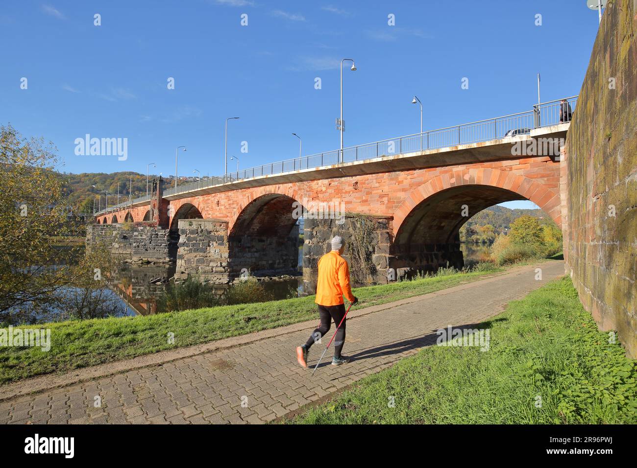 Historic UNESCO Roman Bridge over the Moselle with jogger, pedestrian ...