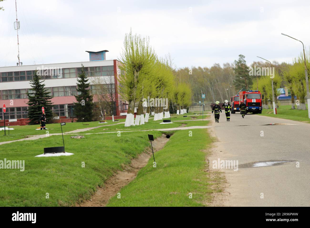 A large red fire rescue vehicle, a truck to extinguish a fire and male ...