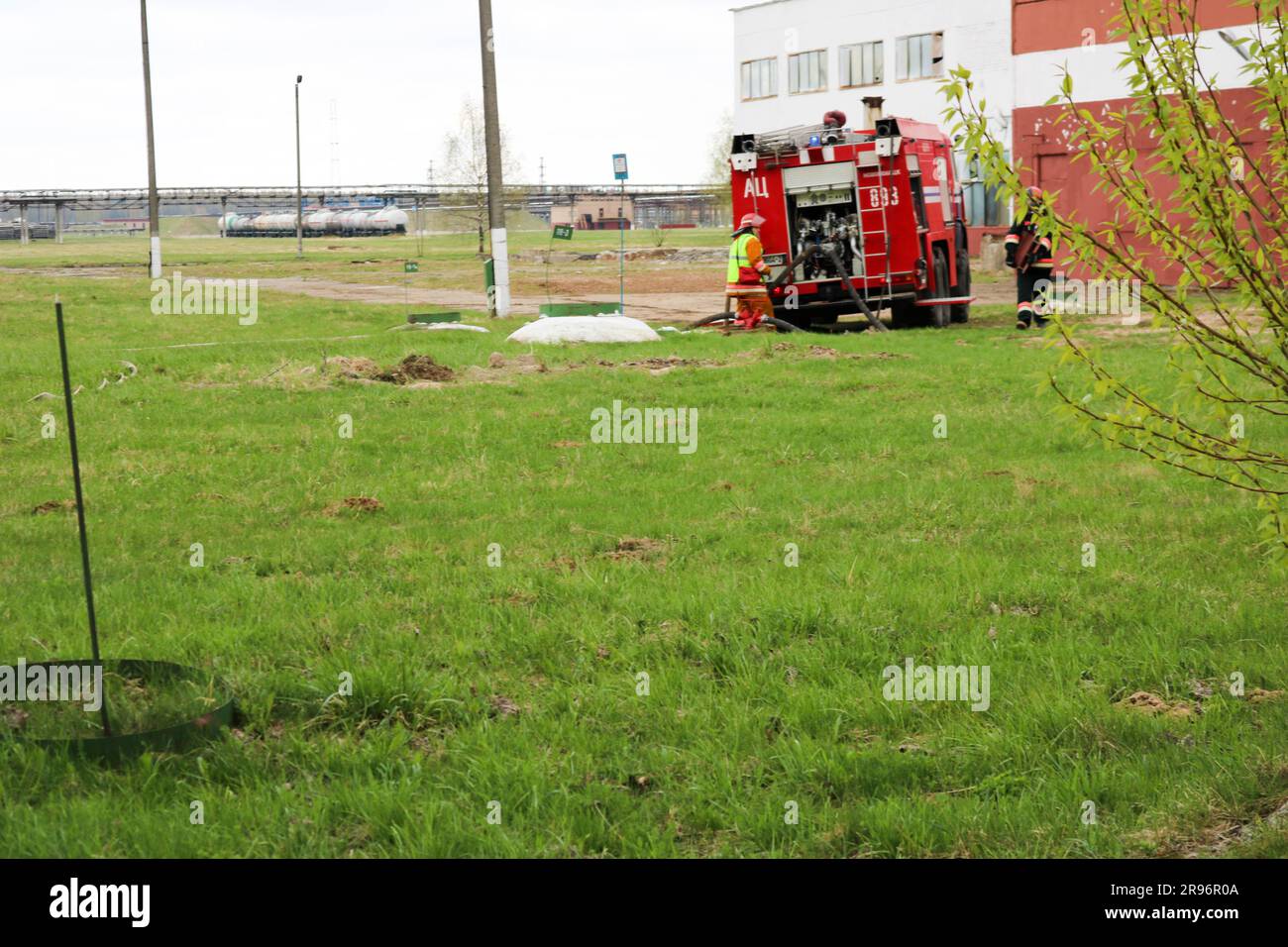 A large red fire rescue vehicle, a truck to extinguish a fire and male ...