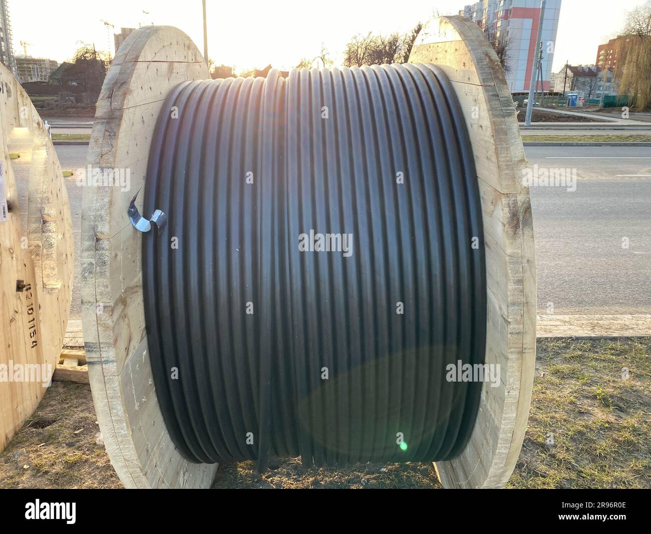 Large round wooden spools of bobbins with wires, black electric cables ...