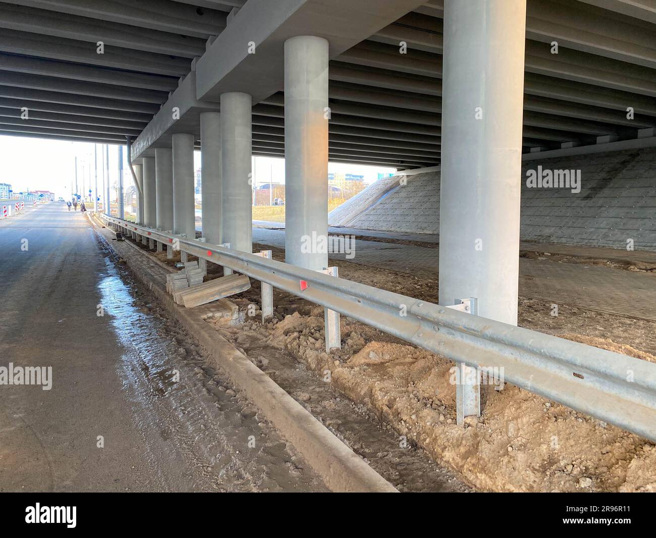 Construction industrial work under a bridge with columns and bumpers ...