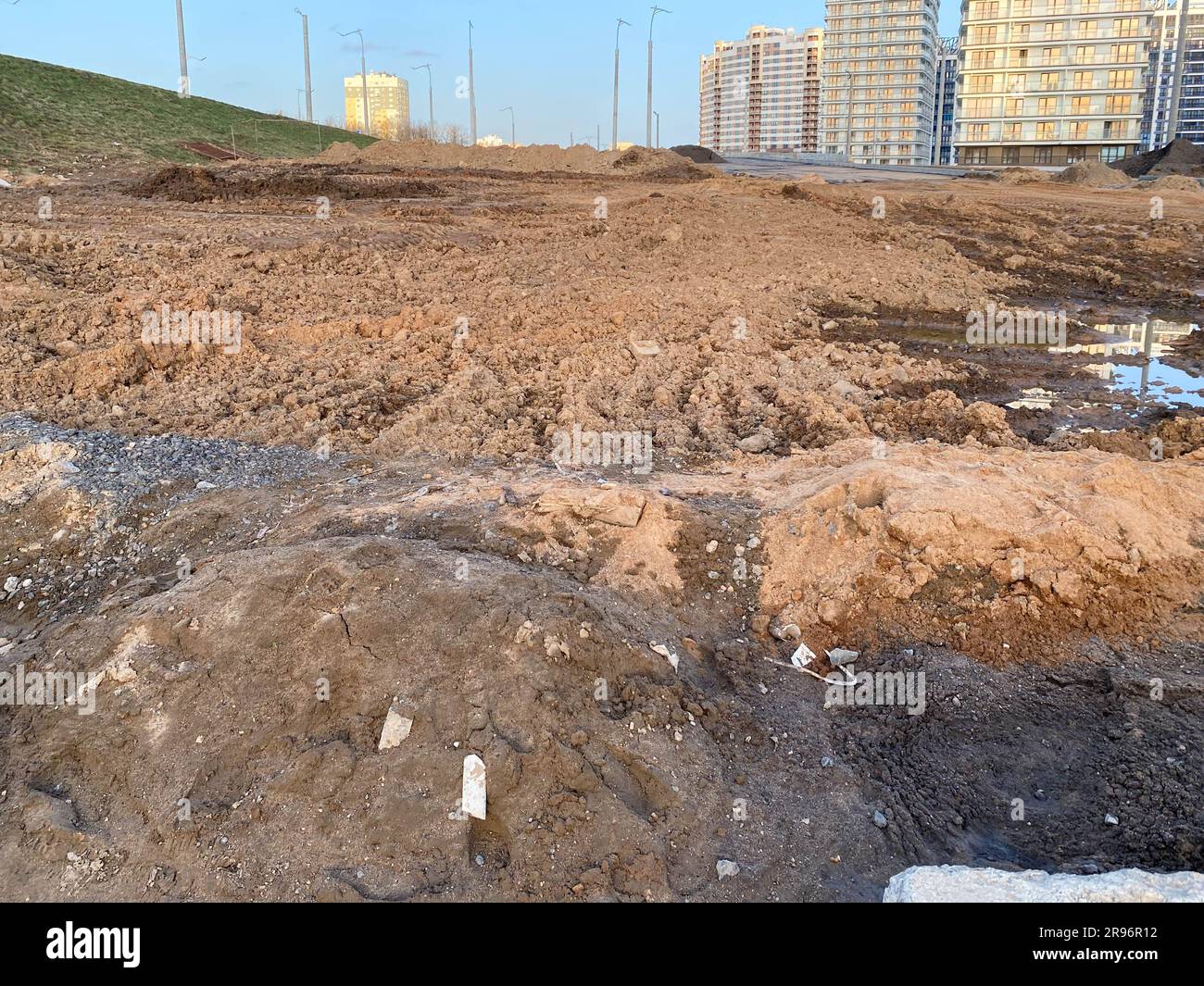 Construction industrial work on the road and brown dug earth with clay ...