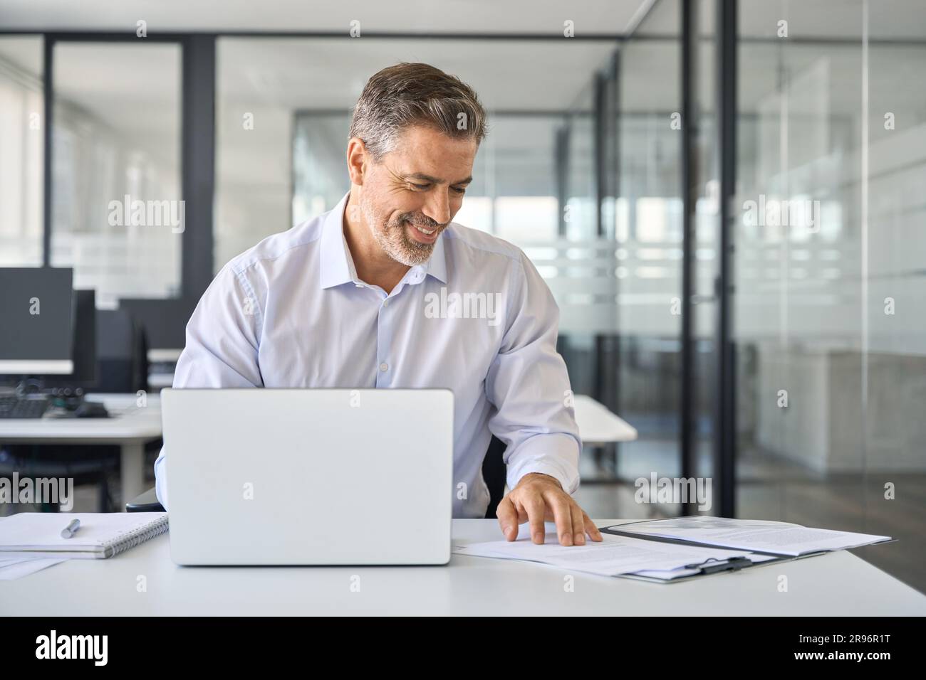 Mid aged professional business man ceo manager checking documents in ...