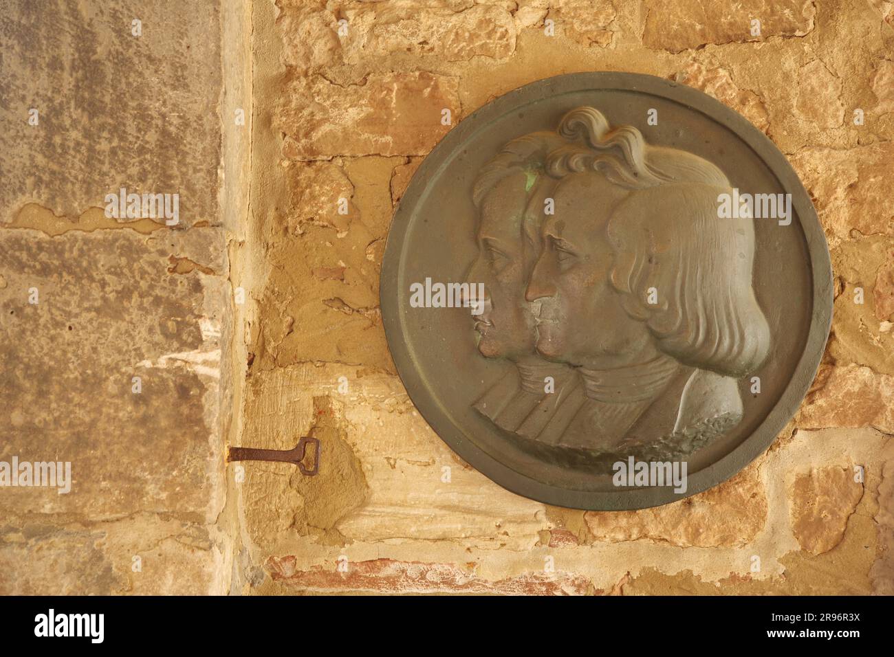 Monument and medallion of the Brothers Grimm on the stone wall of the ...
