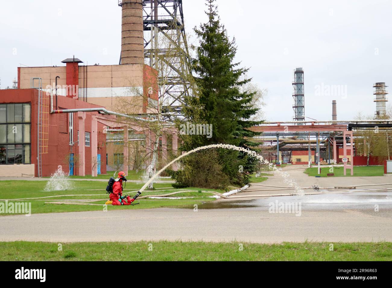 Professional firefighters in orange fire-resistant suits in white ...